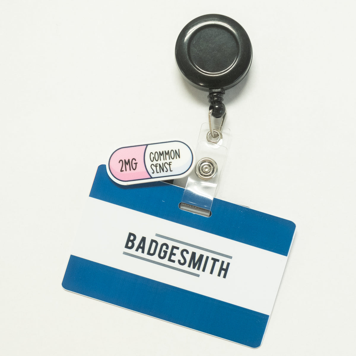 "2mg Common Sense" Pill Badge Charm – BadgeSmith